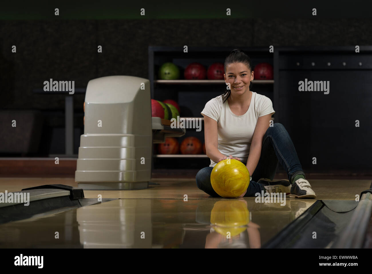 Happy Bowler Sitting At The Bowling Alley Stock Photo - Alamy