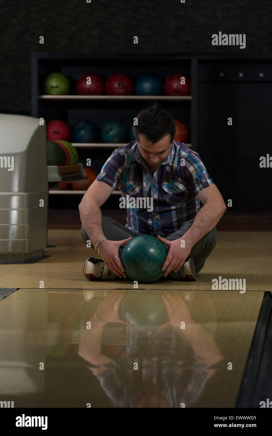 Cheerful Young Man Holding Bowling Ball Stock Photo - Alamy