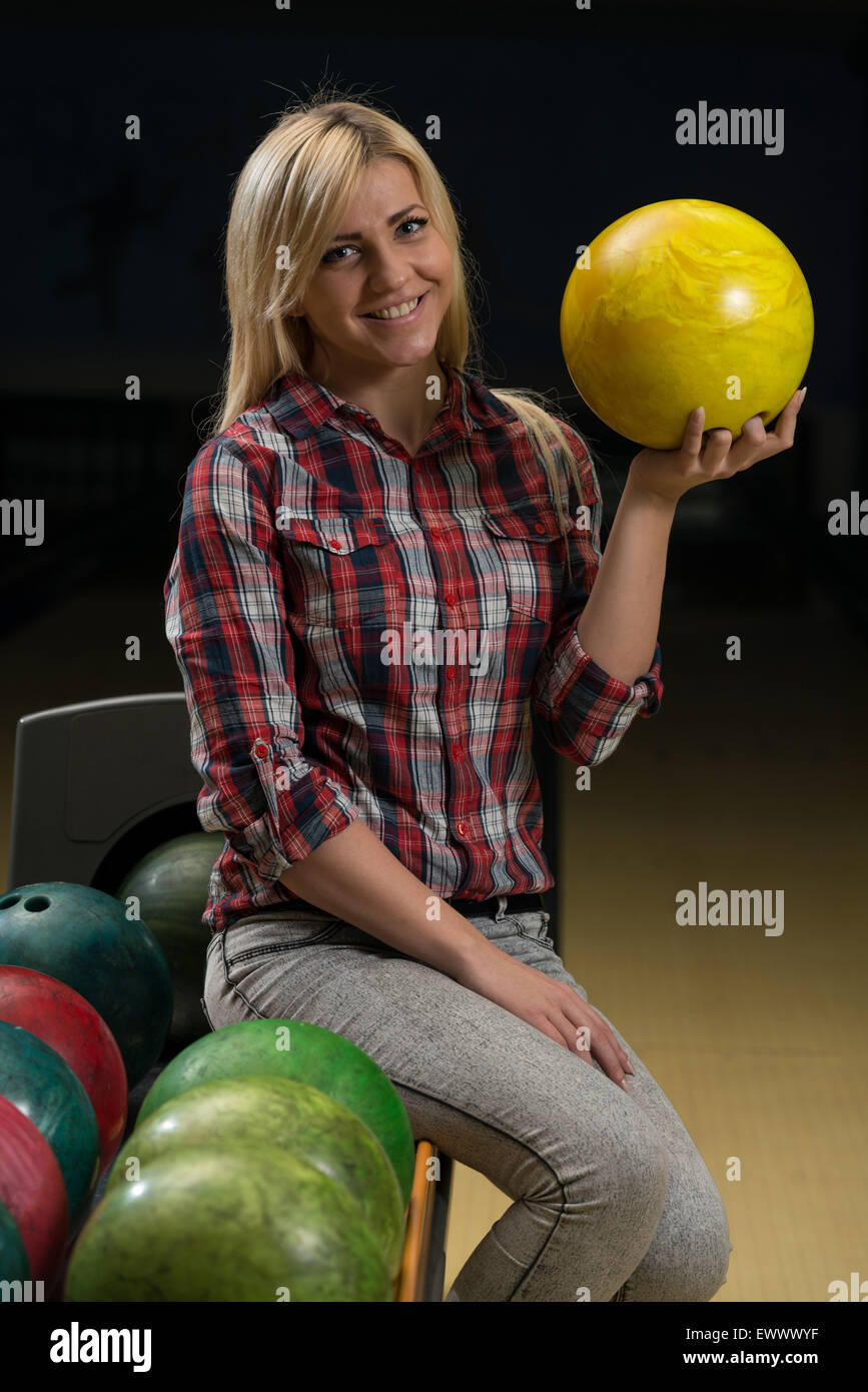 Woman at bowling alley holding bowling ball hi-res stock photography ...