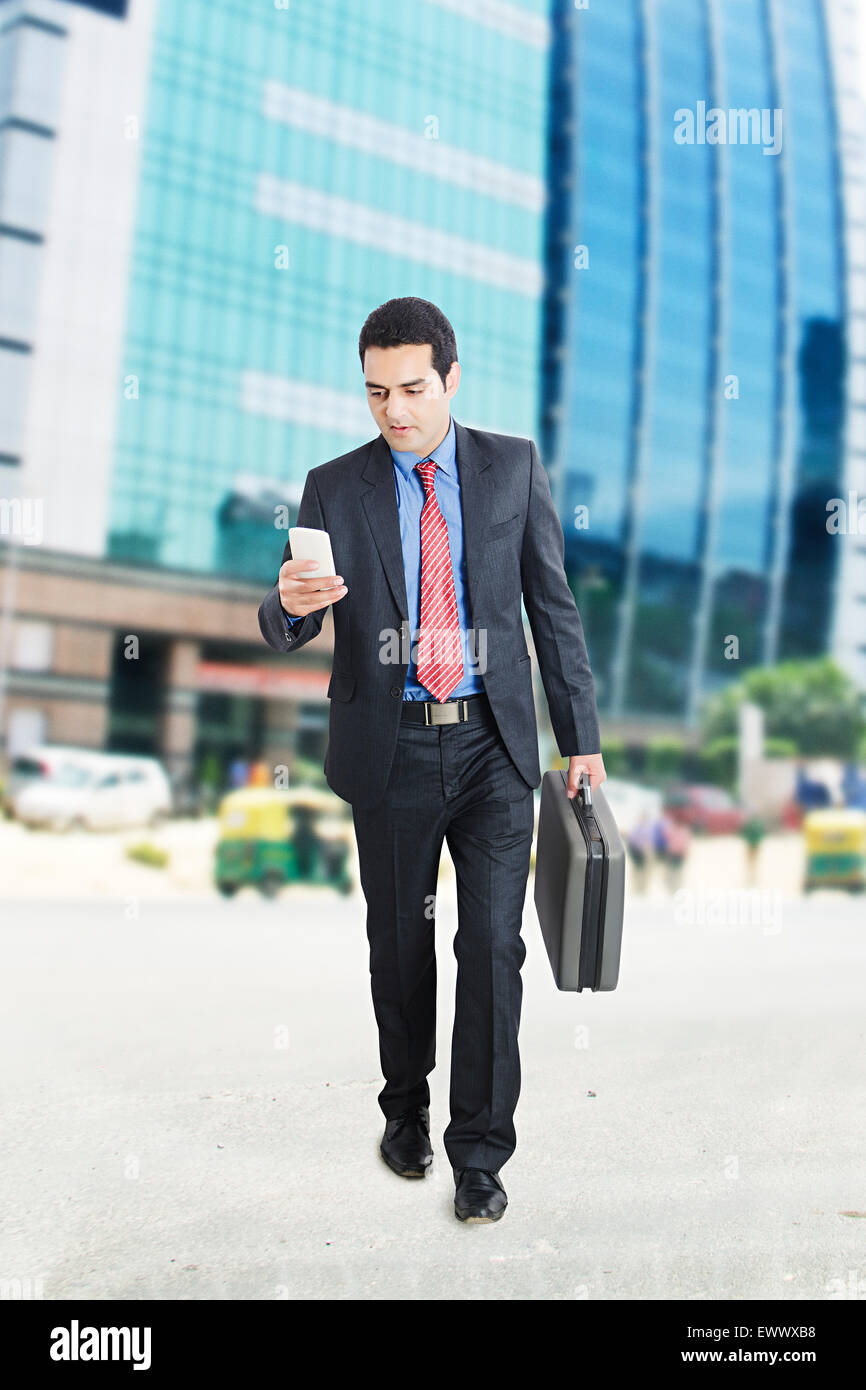 1 indian Business Man Walking Dialing Cell Phone Stock Photo - Alamy