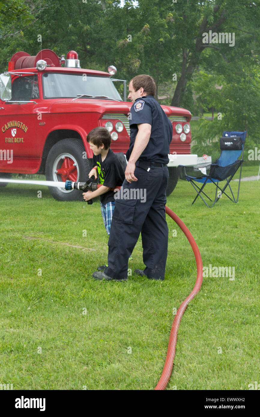 Fireman holding water hose hi-res stock photography and images - Alamy