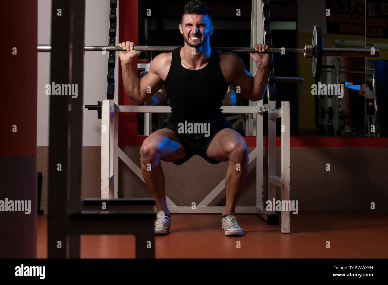 A Physically Fit Men Exercising By Doing Squats Stock Photo - Alamy