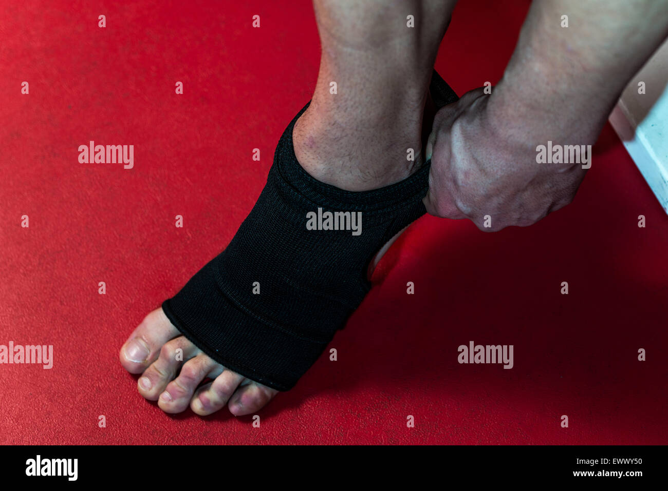 Fighter Putting Straps On His Foot Stock Photo - Alamy