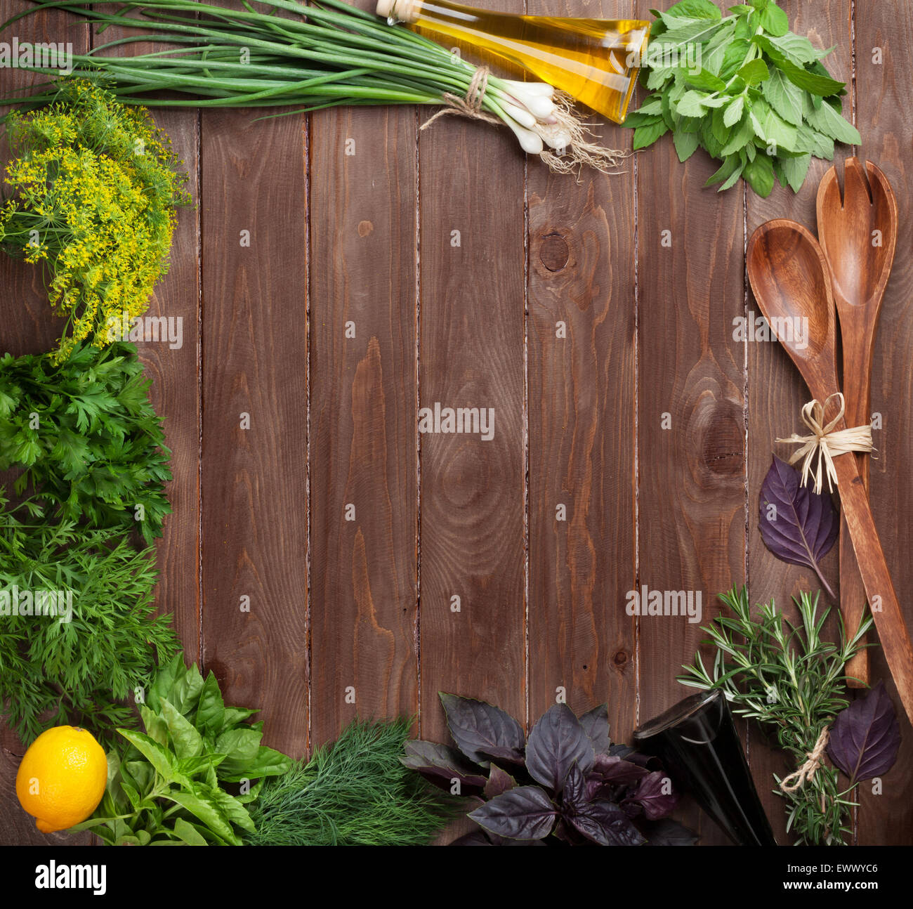 Fresh garden herbs and condiments over wooden table. Top view with copy space Stock Photo - Alamy