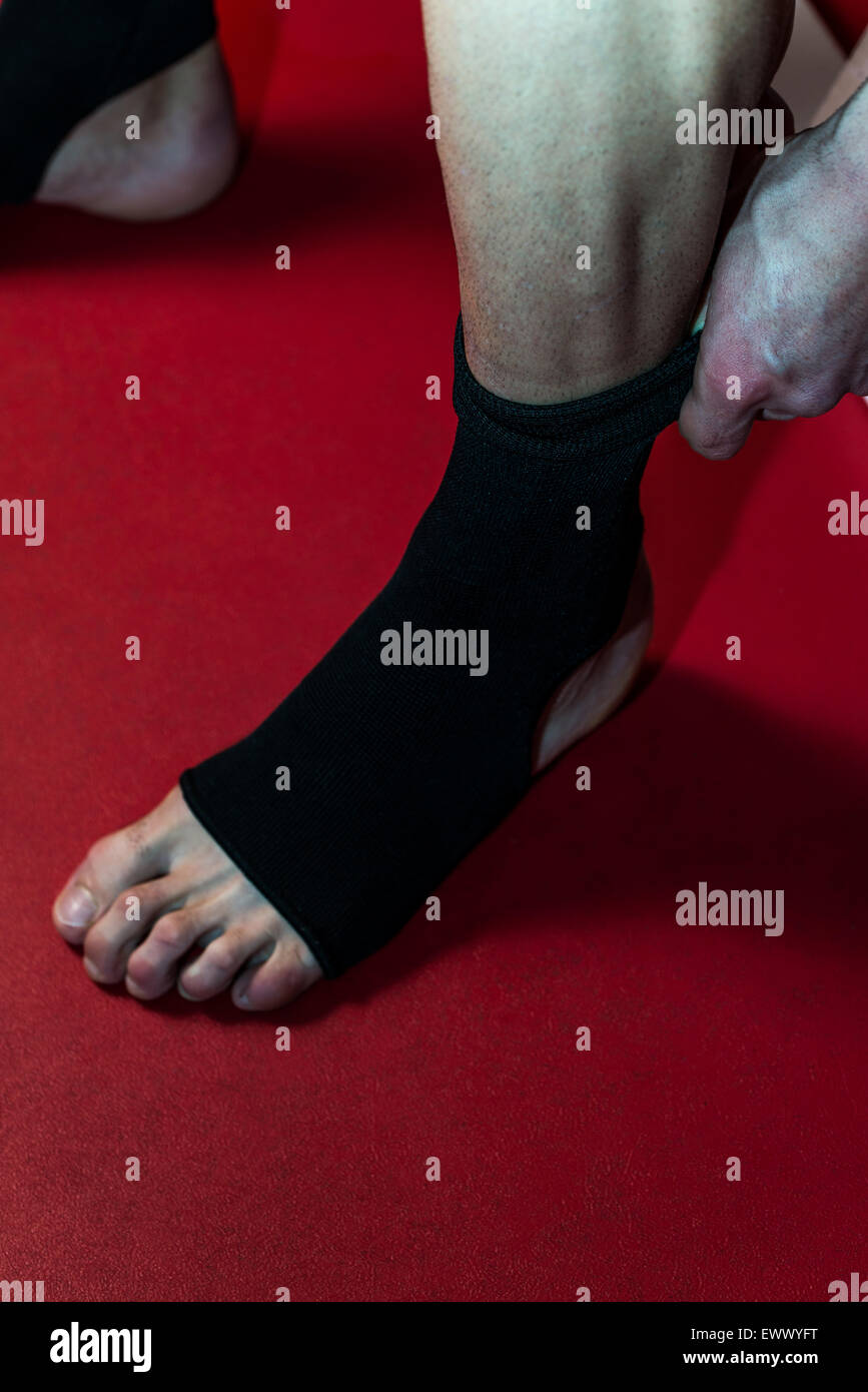 Kick Boxer Putting Straps On His Foot Stock Photo - Alamy