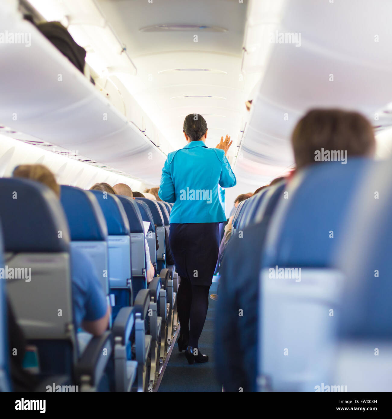Interior of airplane with passengers on seats Stock Photo - Alamy