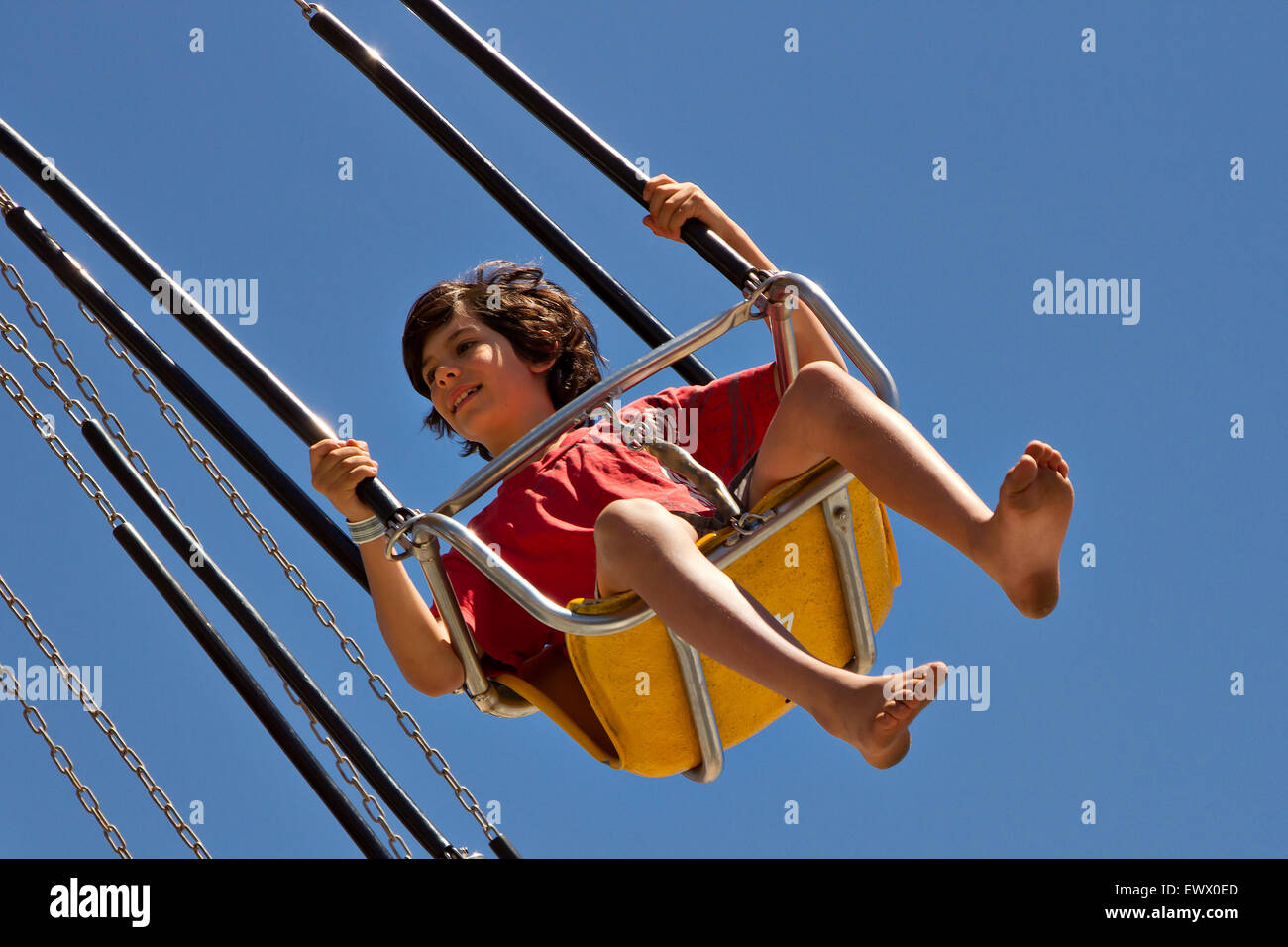 Boy riding a sky ride at an amusement park Stock Photo - Alamy