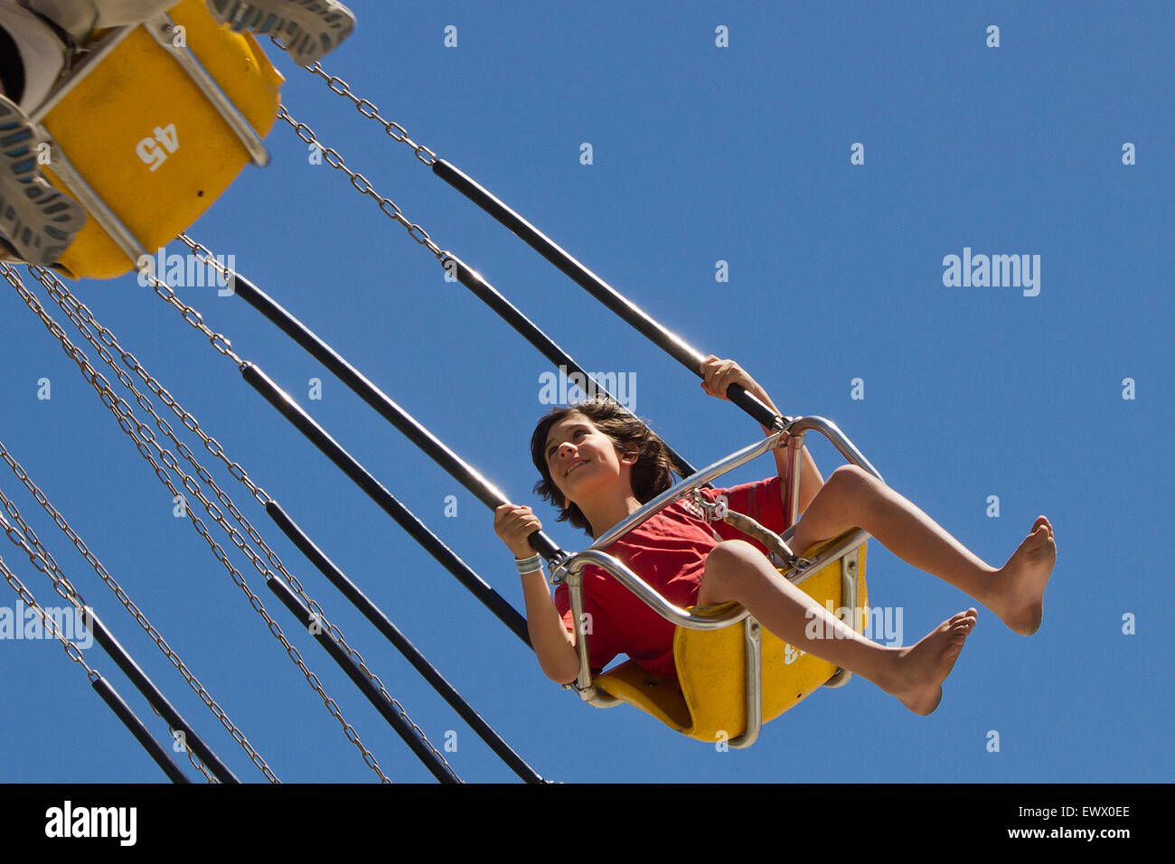 Boy riding a sky ride at an amusement park Stock Photo - Alamy
