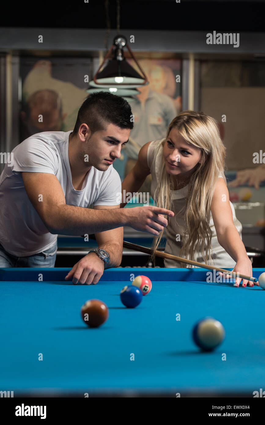 Man Teaching Woman How To Play Pool Stock Photo - Alamy