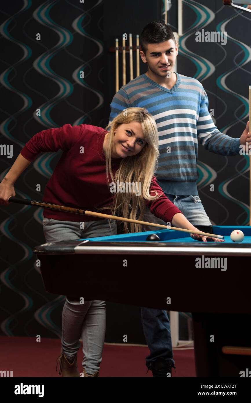 Man Teaching Woman How To Play Pool Stock Photo - Alamy