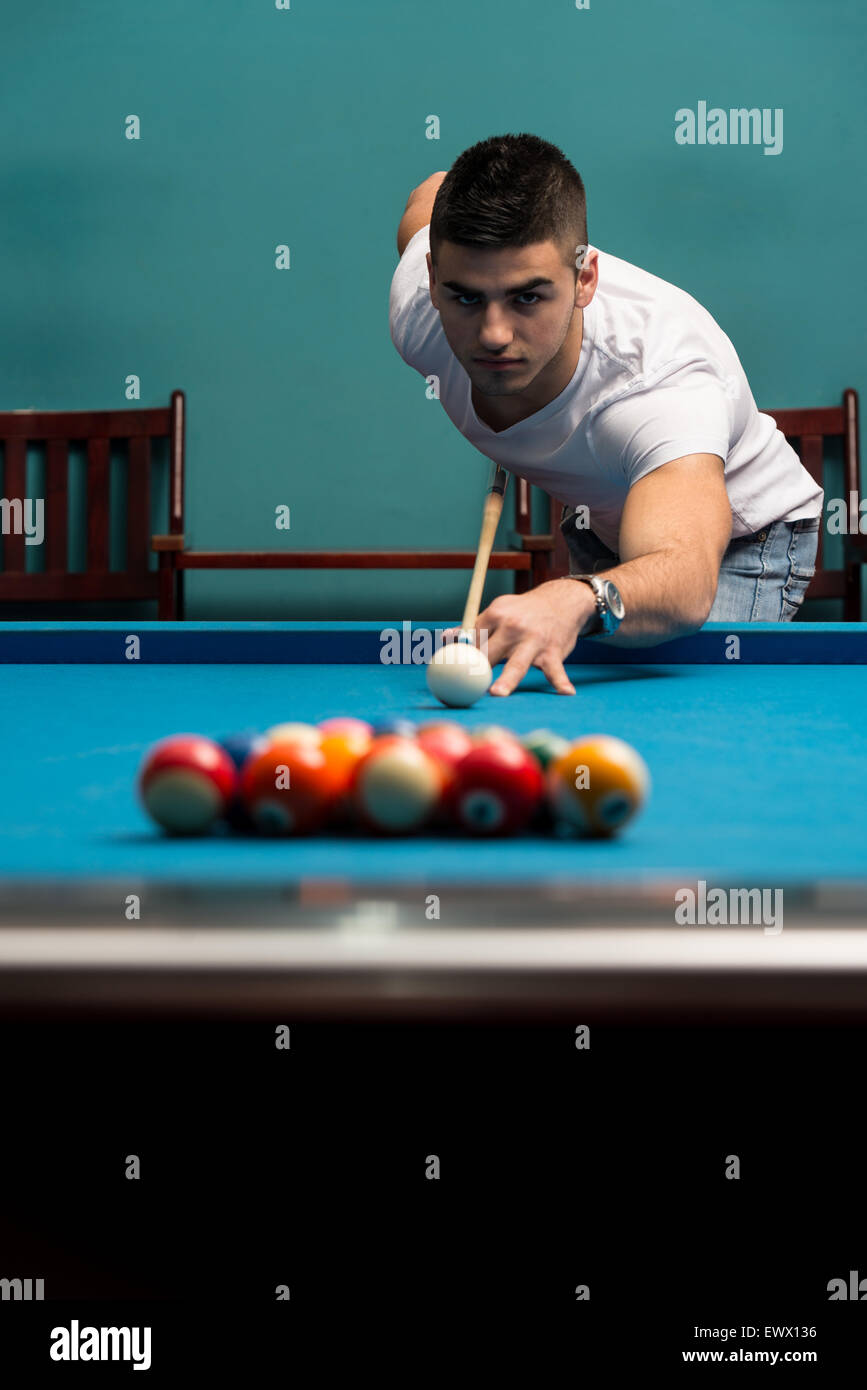 Young Men Lining To Hit Ball On Pool Table Stock Photo - Alamy