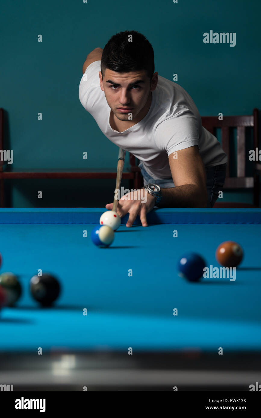 Young Men Lining To Hit Ball On Pool Table Stock Photo - Alamy