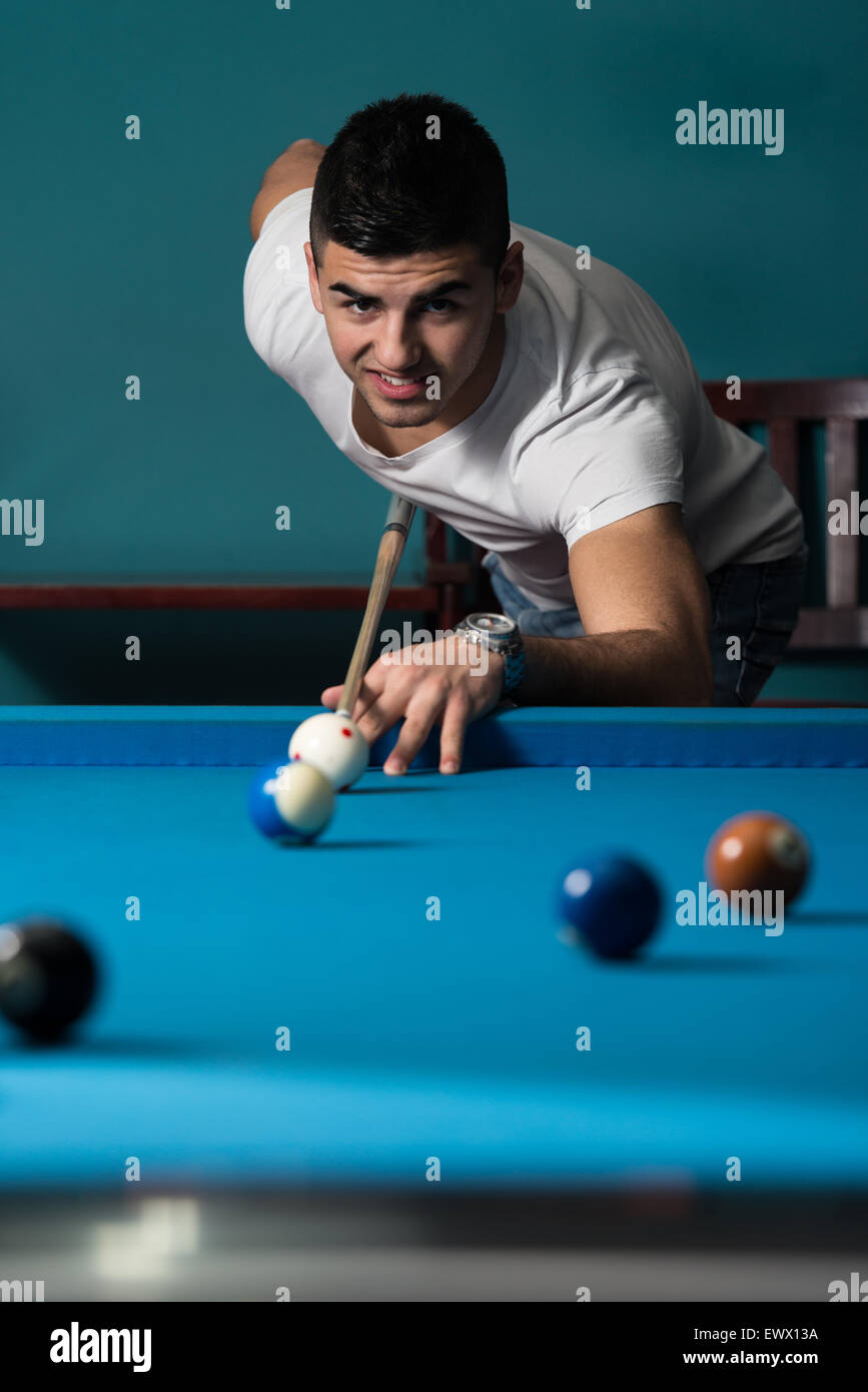 Young Men Lining To Hit Ball On Pool Table Stock Photo - Alamy