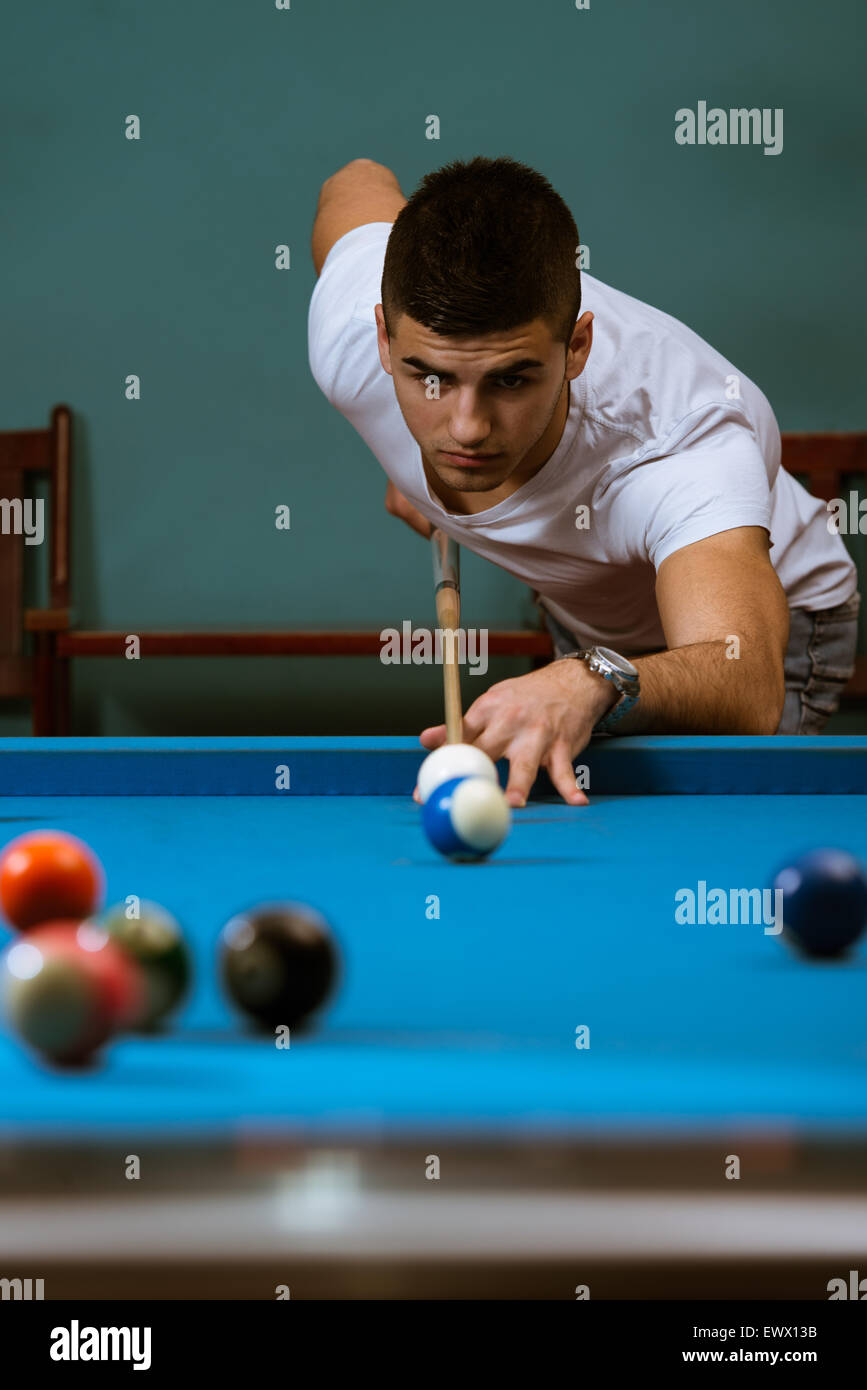 Young Men Lining To Hit Ball On Pool Table Stock Photo - Alamy