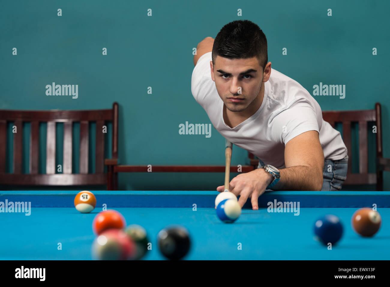 Young Men Lining To Hit Ball On Pool Table Stock Photo - Alamy