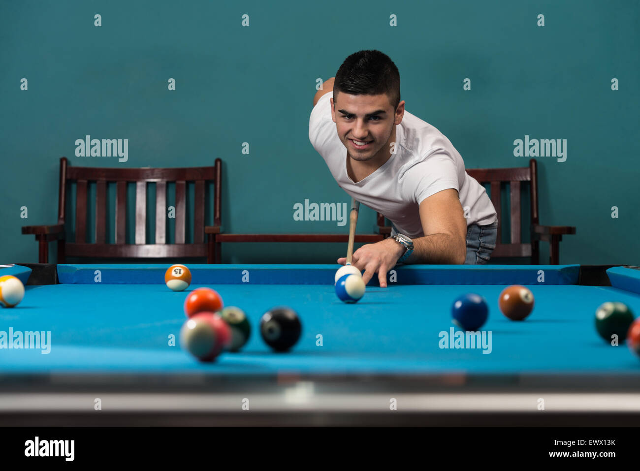 Young Men Lining To Hit Ball On Pool Table Stock Photo - Alamy