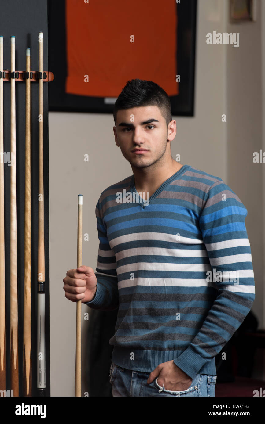 Portrait Of A Young Male Model Playing Billiards Stock Photo - Alamy