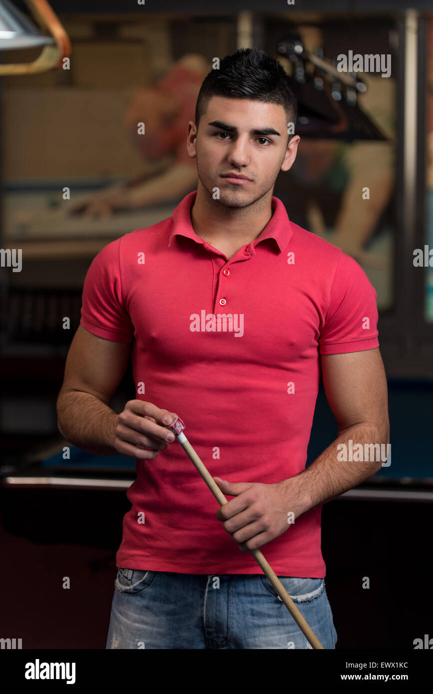 Portrait Of A Young Male Model Playing Billiards Stock Photo - Alamy