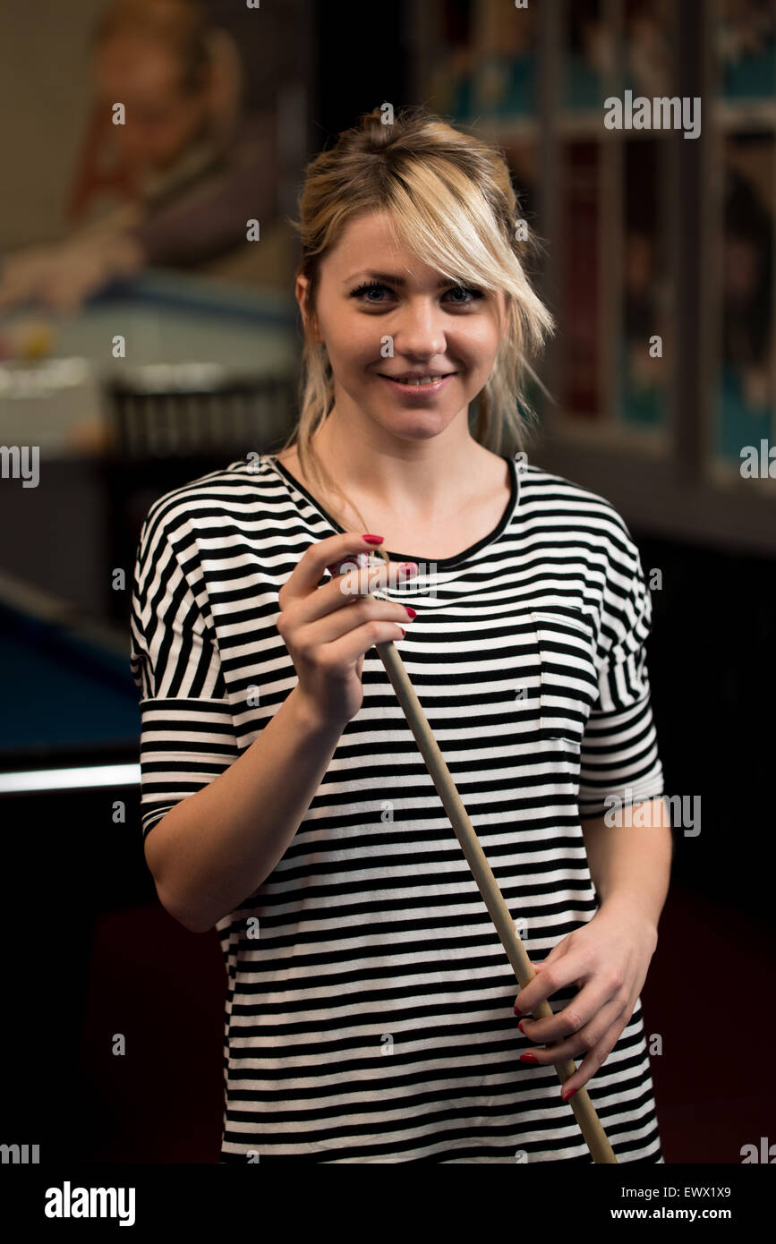 Portrait Of A Young Female Model Playing Billiards Stock Photo - Alamy