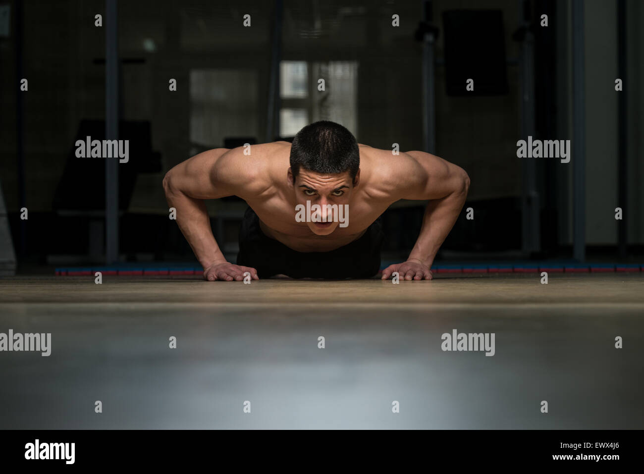Young Man Doing Press Ups In Gym Stock Photo - Alamy