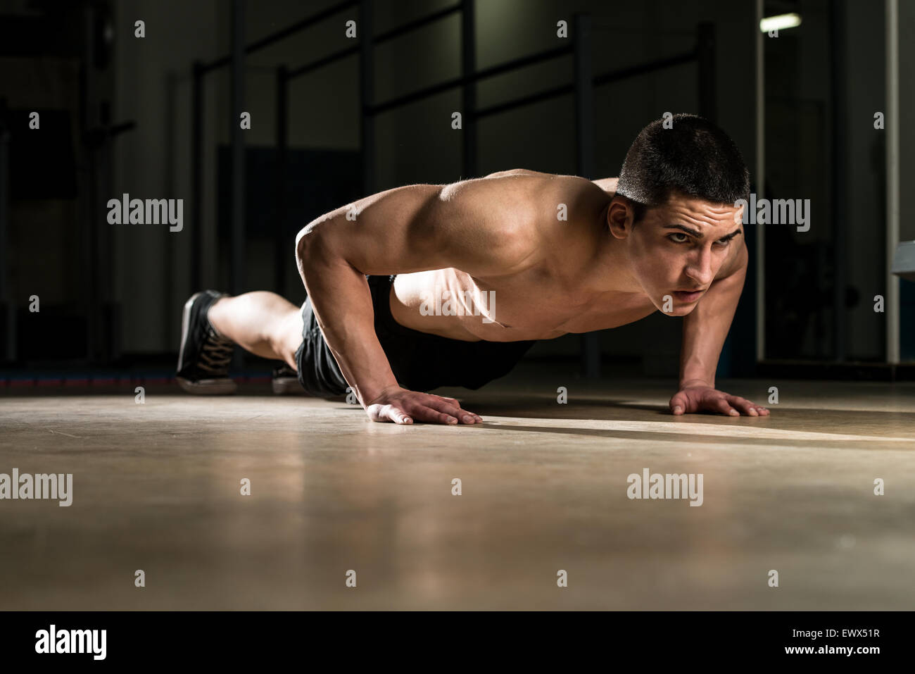Young Man Doing Press Ups In Gym Stock Photo - Alamy