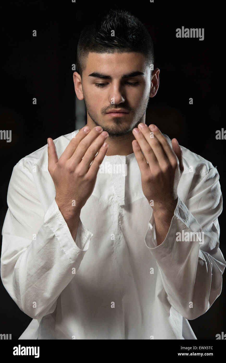 Young man at prayer hi-res stock photography and images - Alamy