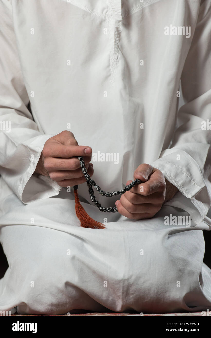 Young Muslim Man Making Traditional Prayer To God While Wearing A ...