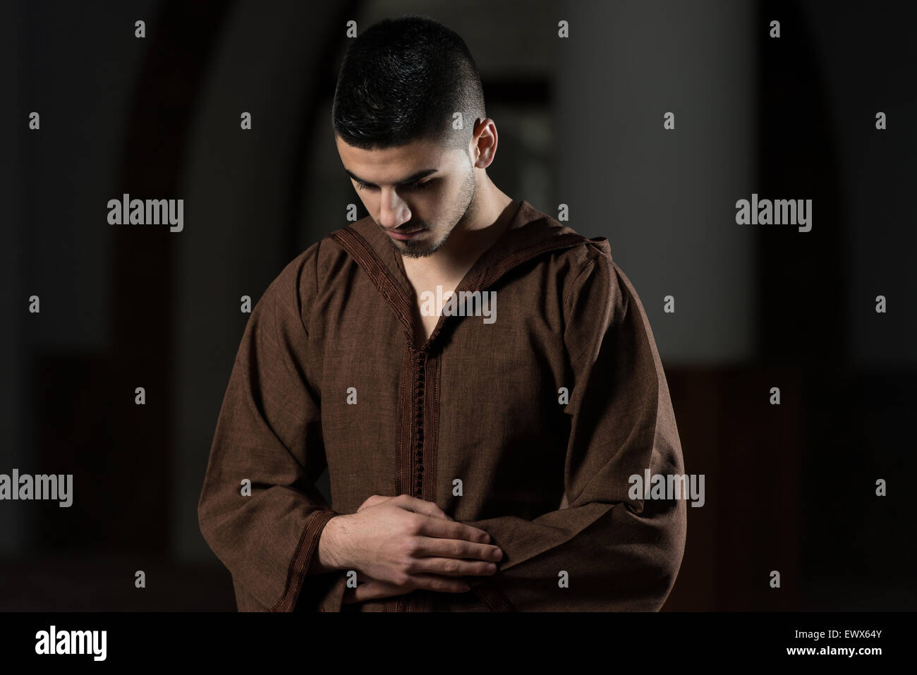 Young Muslim Man Making Traditional Prayer To God While Wearing A ...