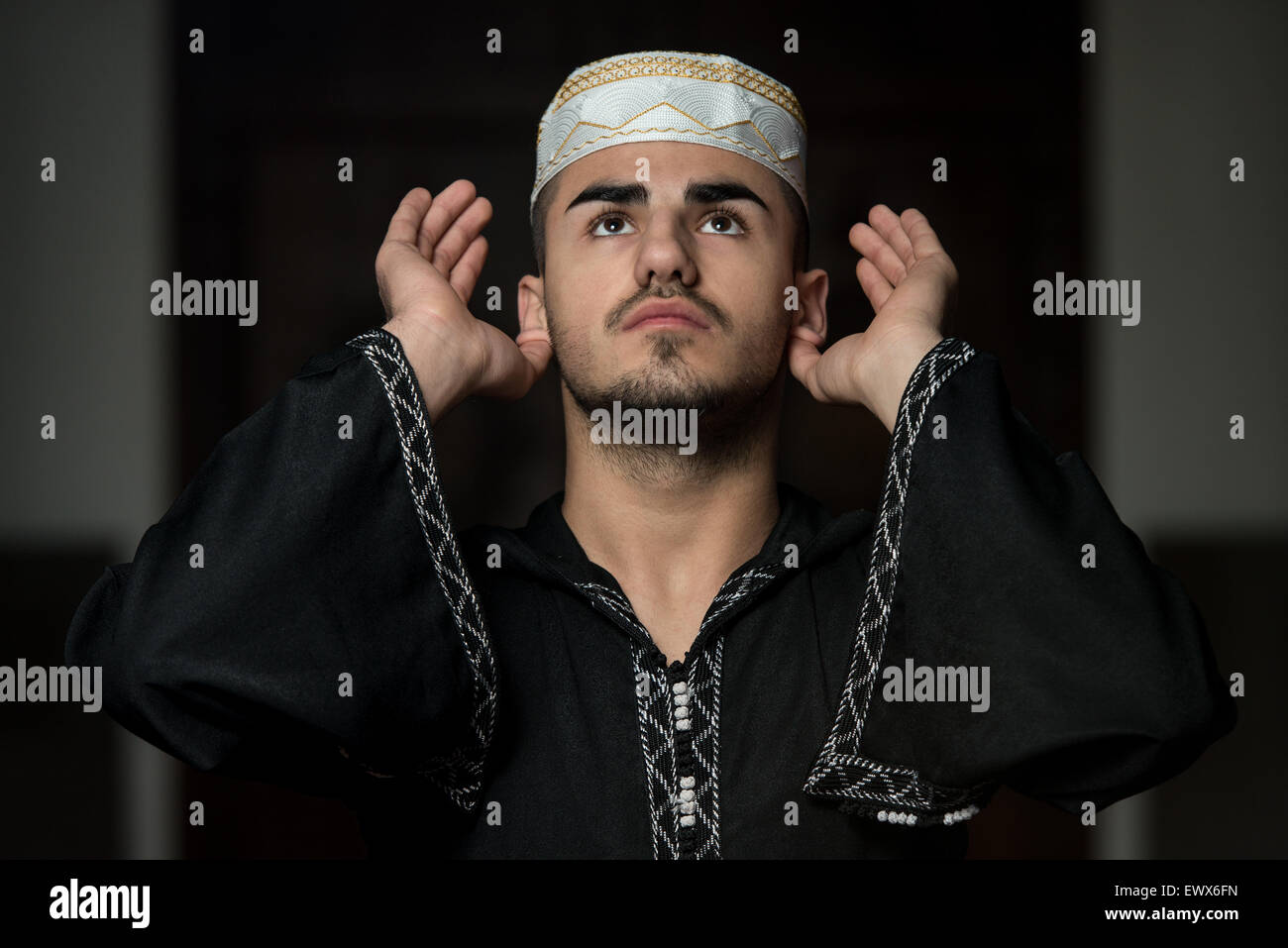 Young Muslim Guy Making Traditional Prayer To God While Wearing A ...