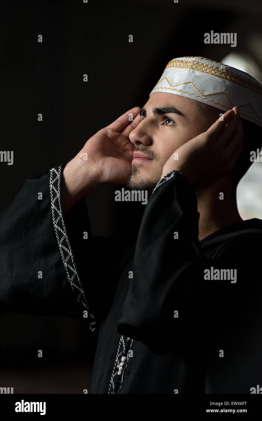 Young Muslim Guy Making Traditional Prayer To God While Wearing A ...