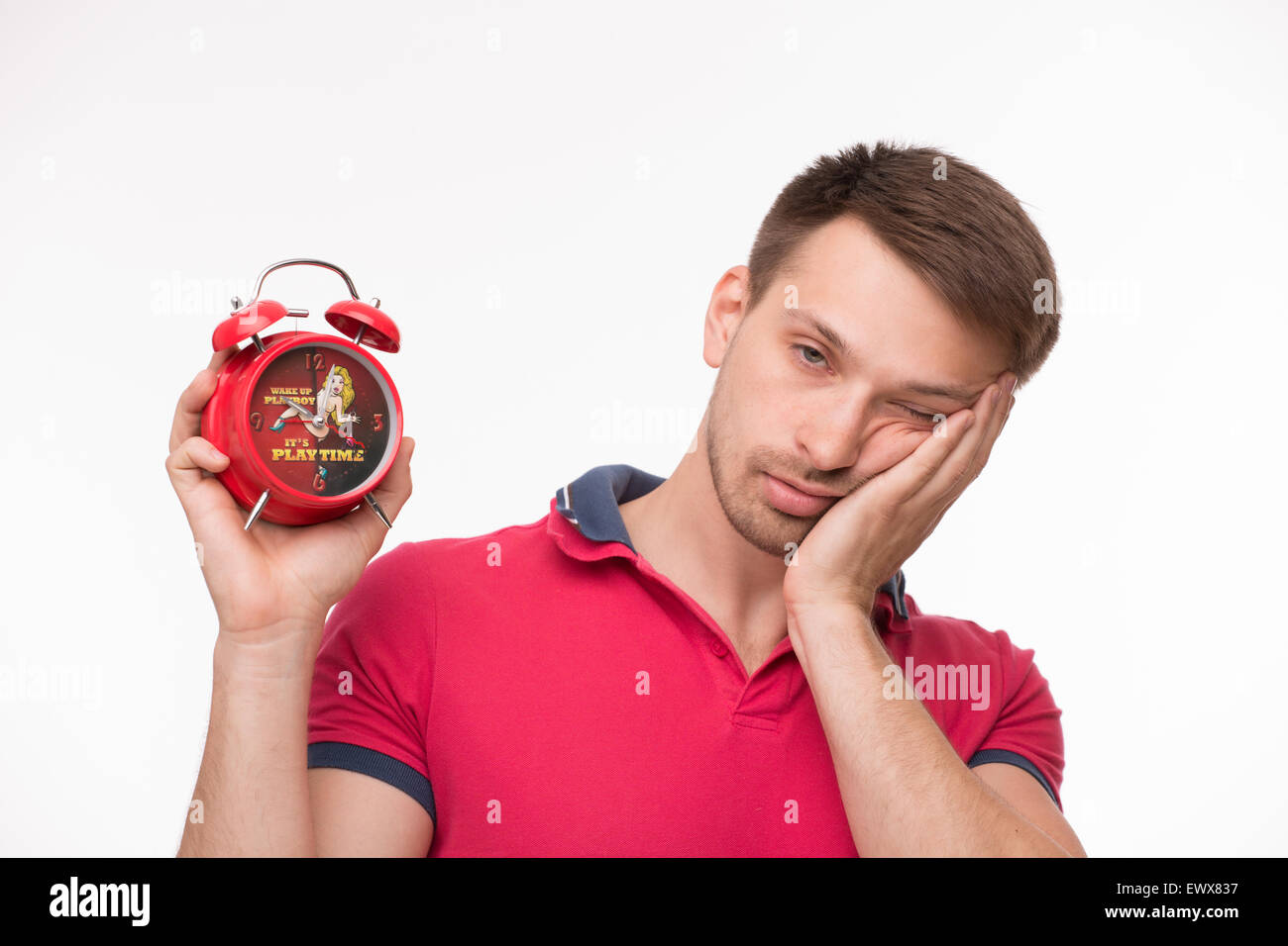 Young man with alarm clock Stock Photo - Alamy