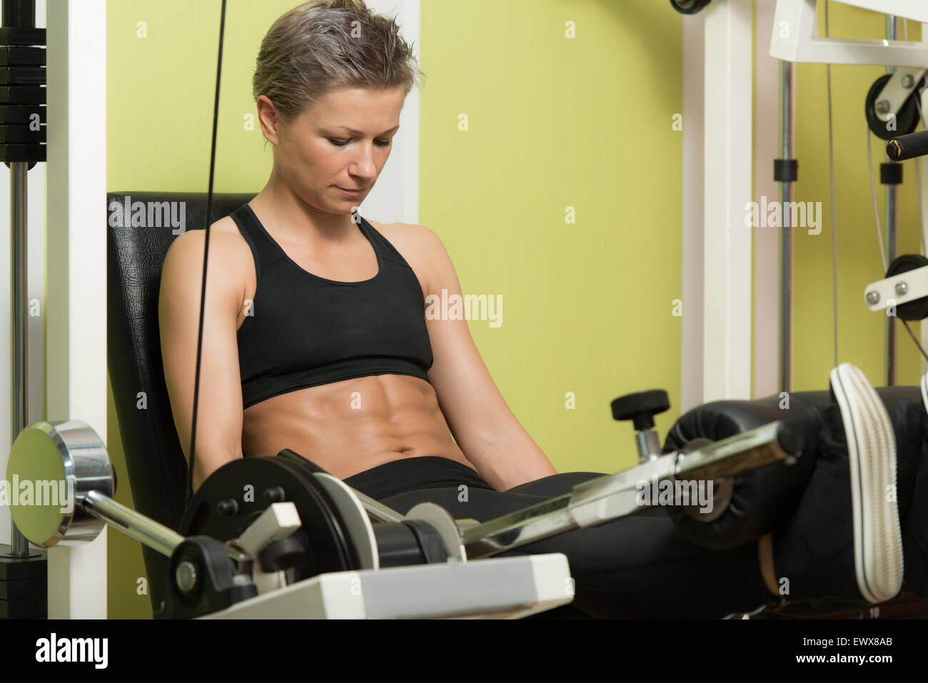 Young Women Exercising Her Legs Doing Leg Extensions Stock Photo - Alamy