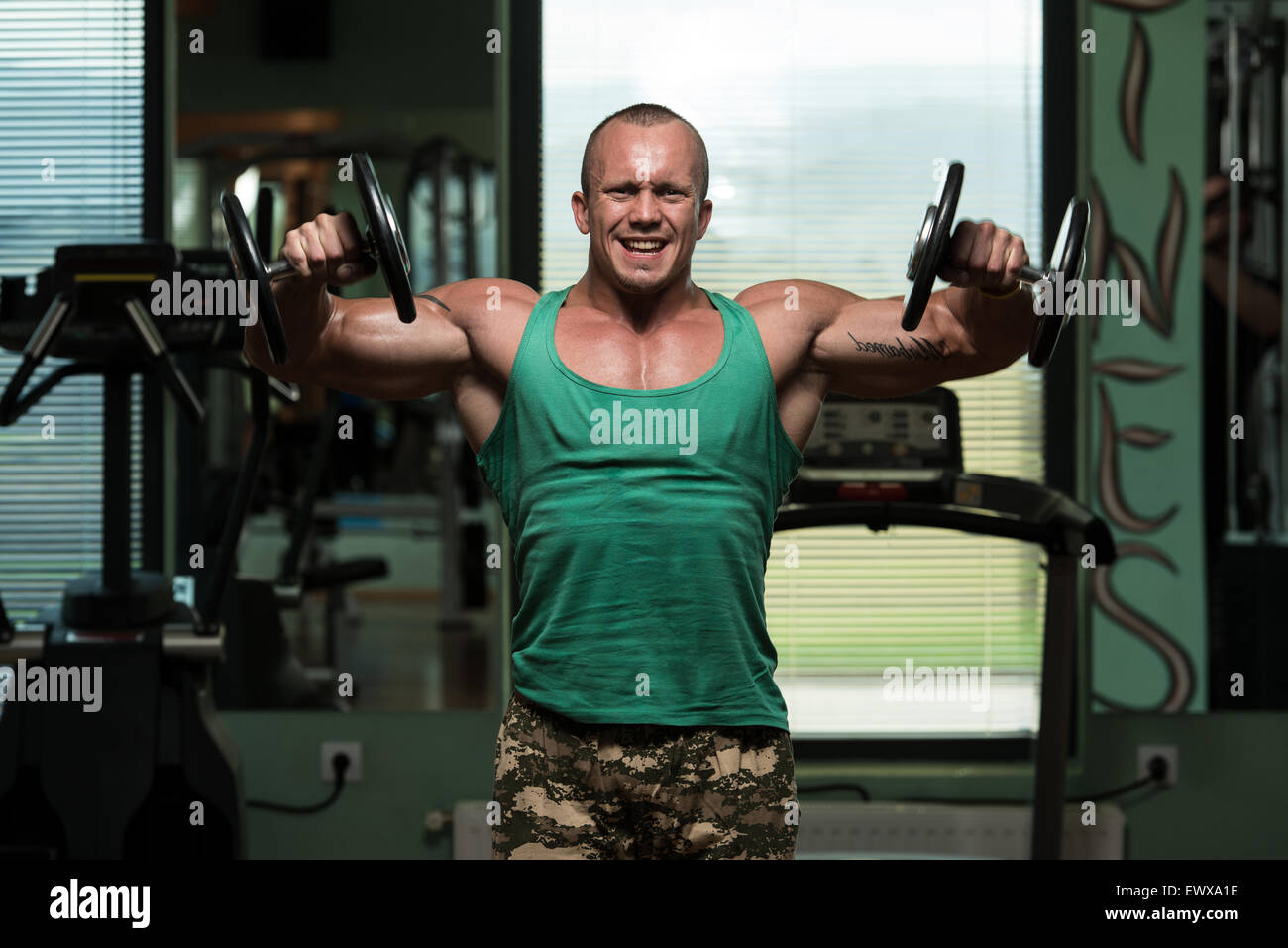 Young Man Preforming Dumbbell Lateral Raise - Exercise For Shoulders ...