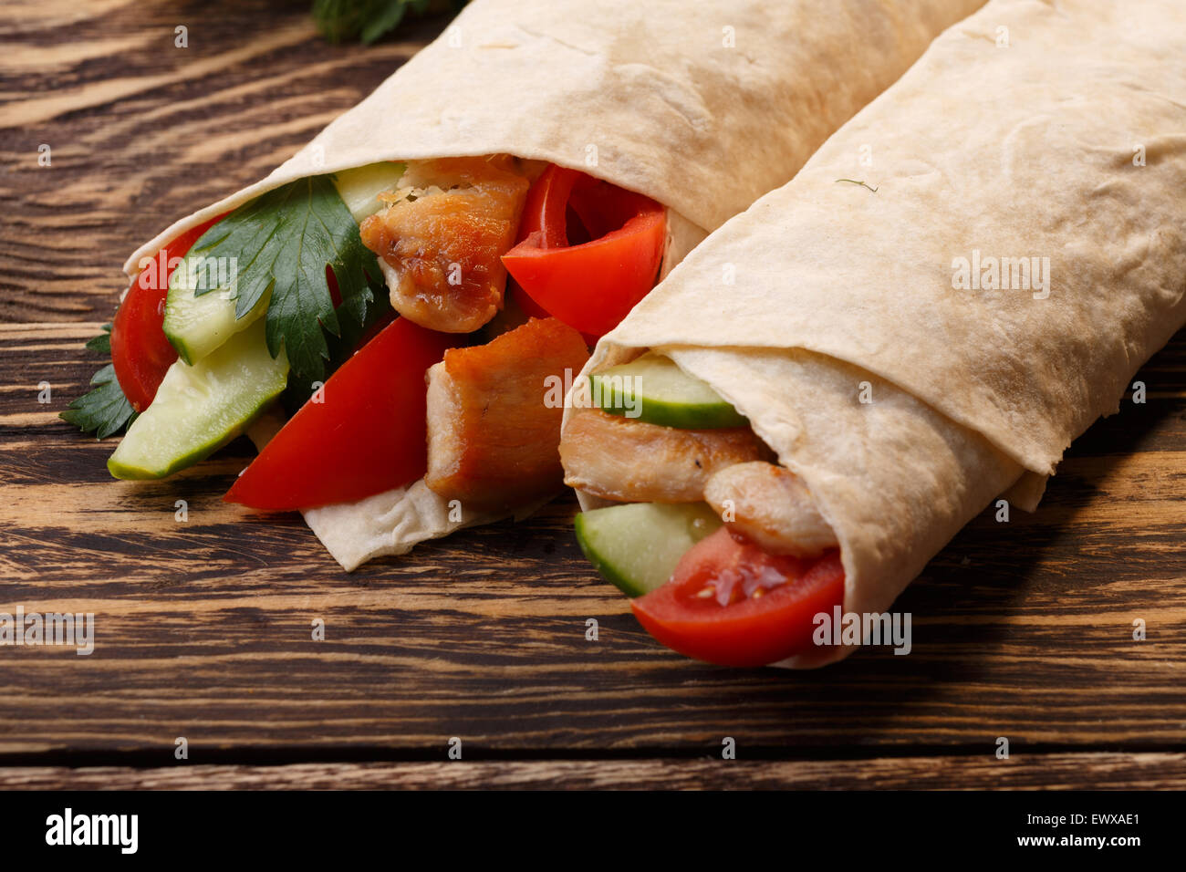 Traditional shawarma wrap with chicken and vegetables. Focus on ...