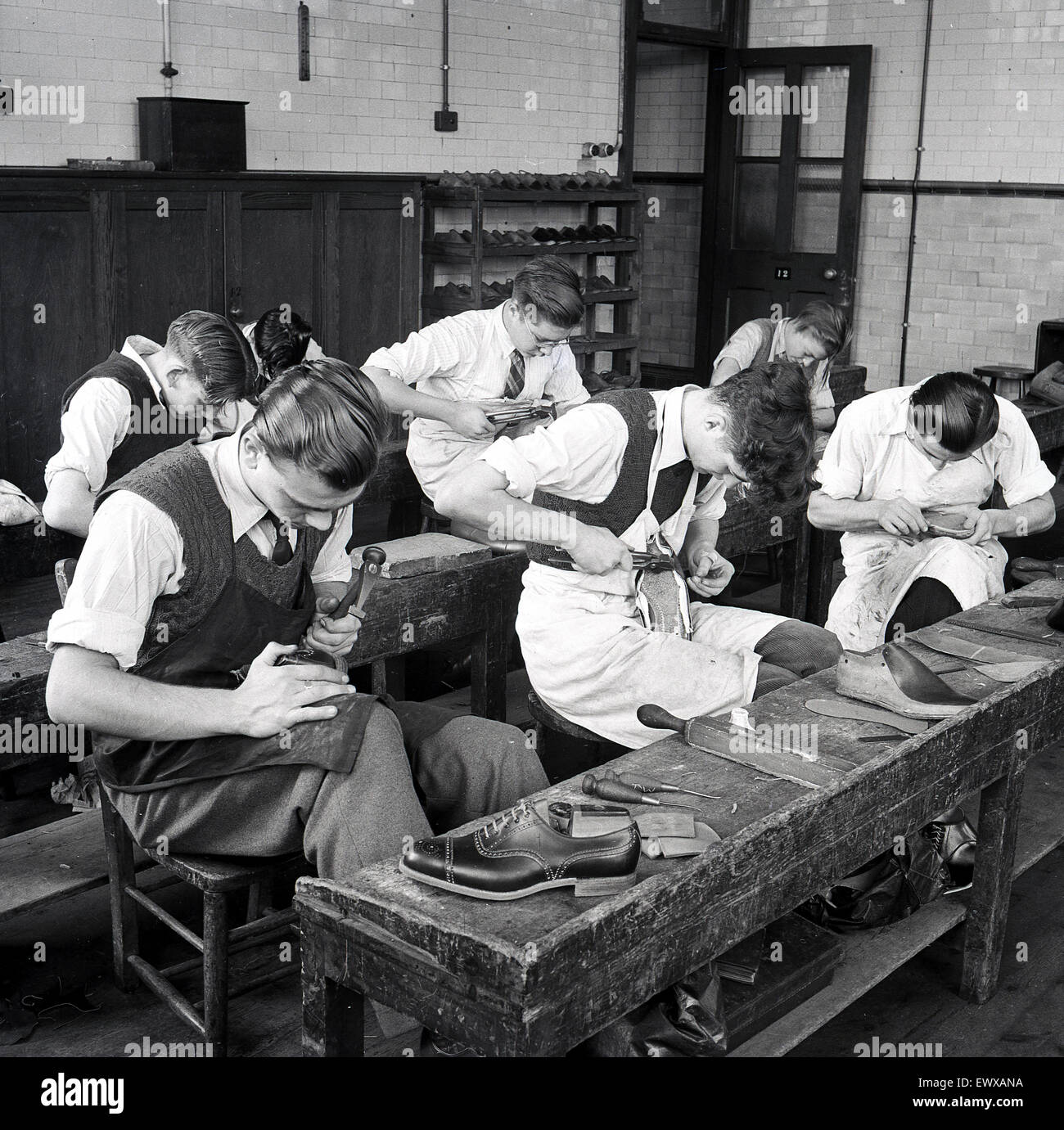 Historical, 1950s, picture shows a group of apprentice male shoemakers ...