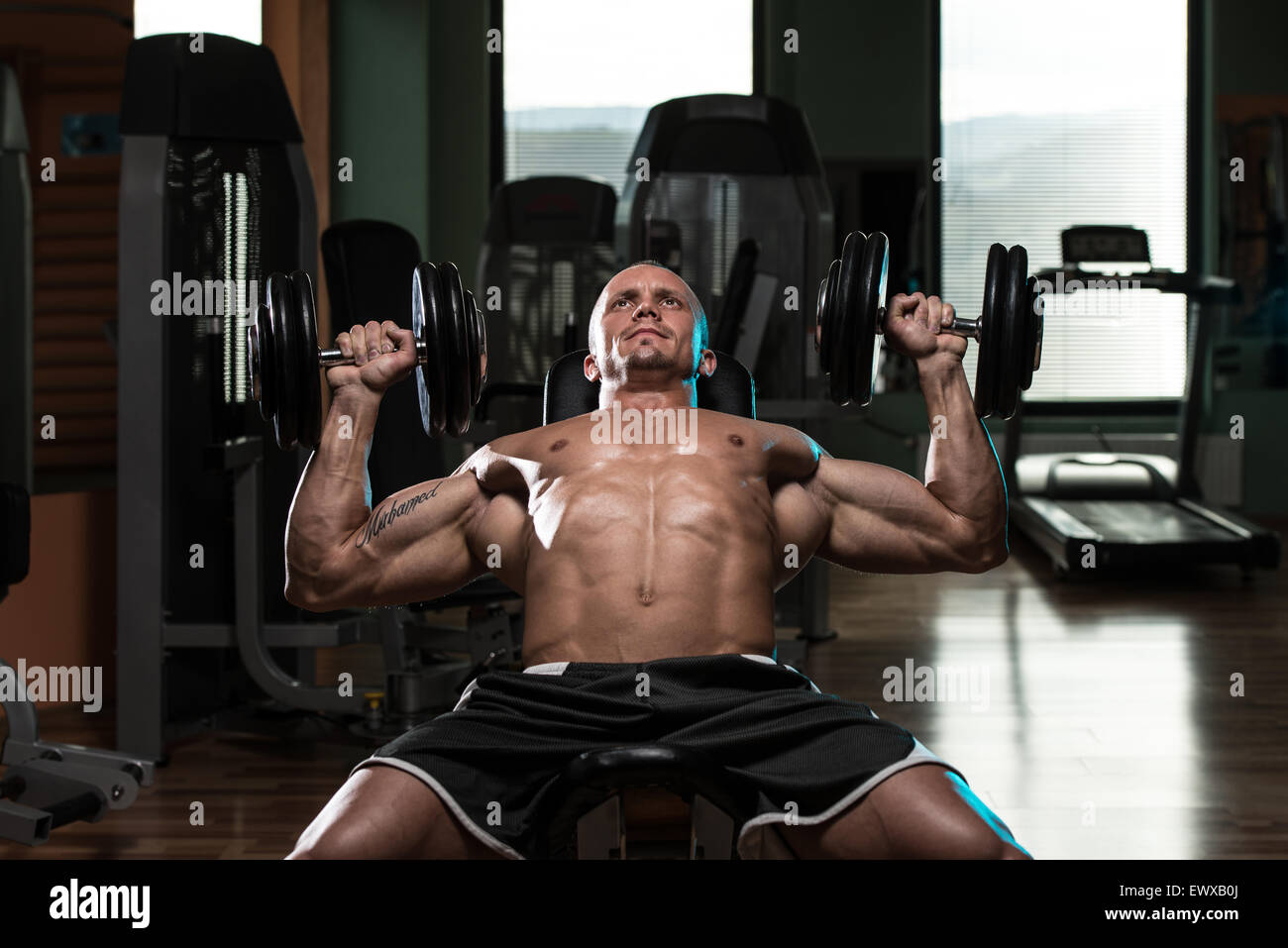 Handsome Young Man Doing Dumbbell Incline Bench Press Workout In Gym ...