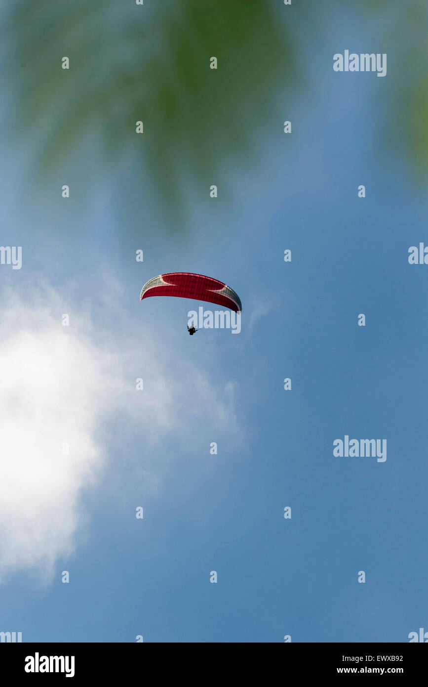 Paragliding on the Canary Islands. Red paraglider against blue sky ...