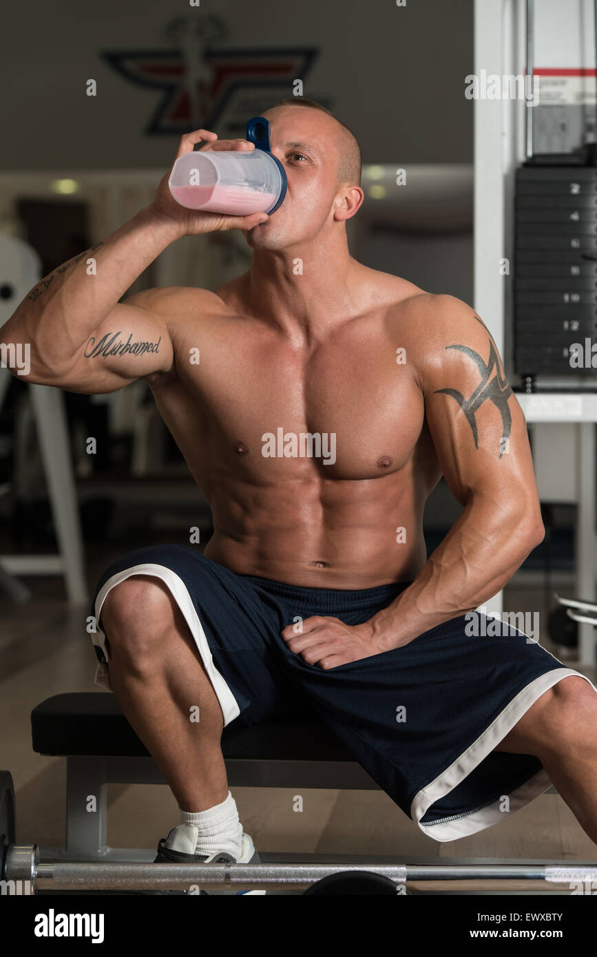 Handsome Muscular Man Drinking Protein Drink Stock Photo - Alamy