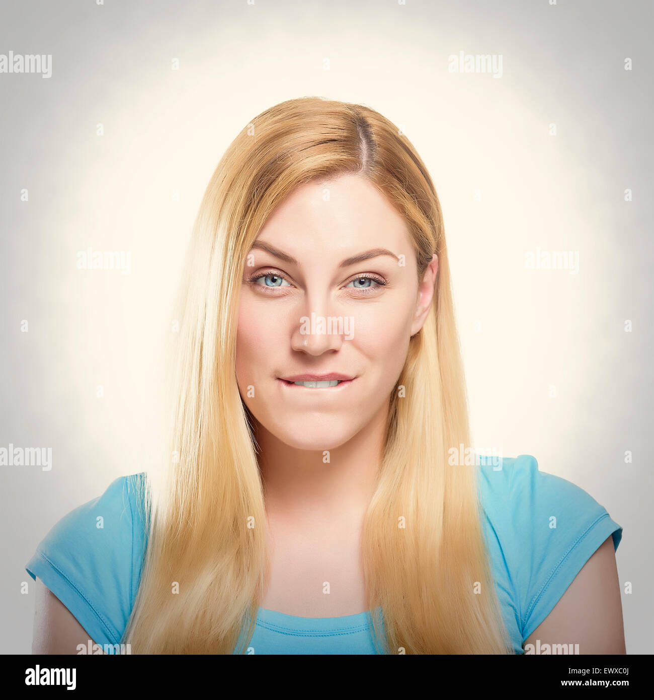 Blond woman bit her lip Stock Photo - Alamy
