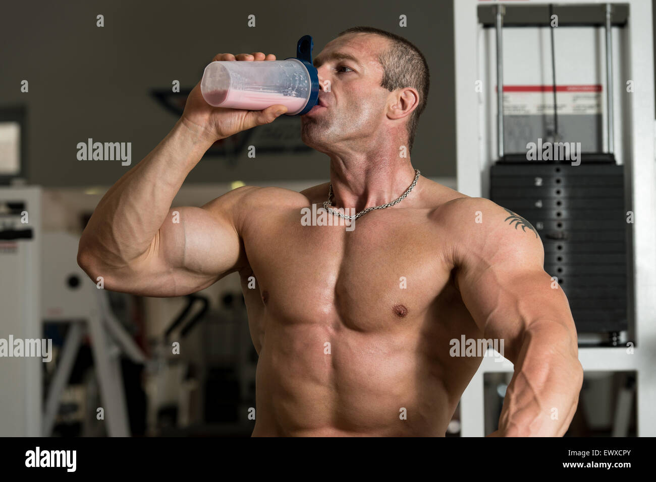 Handsome Muscular Man Drinking Protein Drink Stock Photo - Alamy
