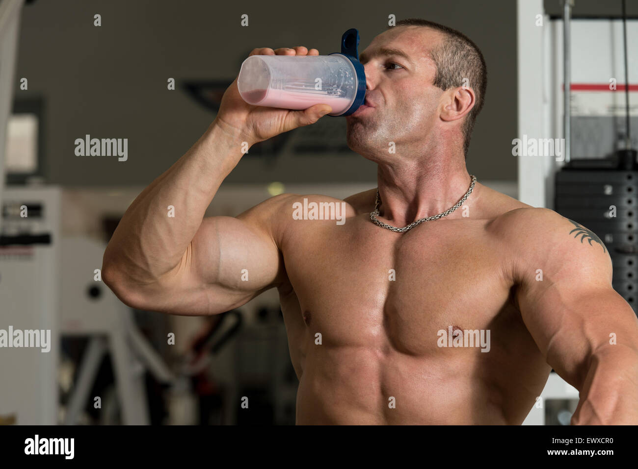 Handsome Muscular Man Drinking Protein Drink Stock Photo - Alamy