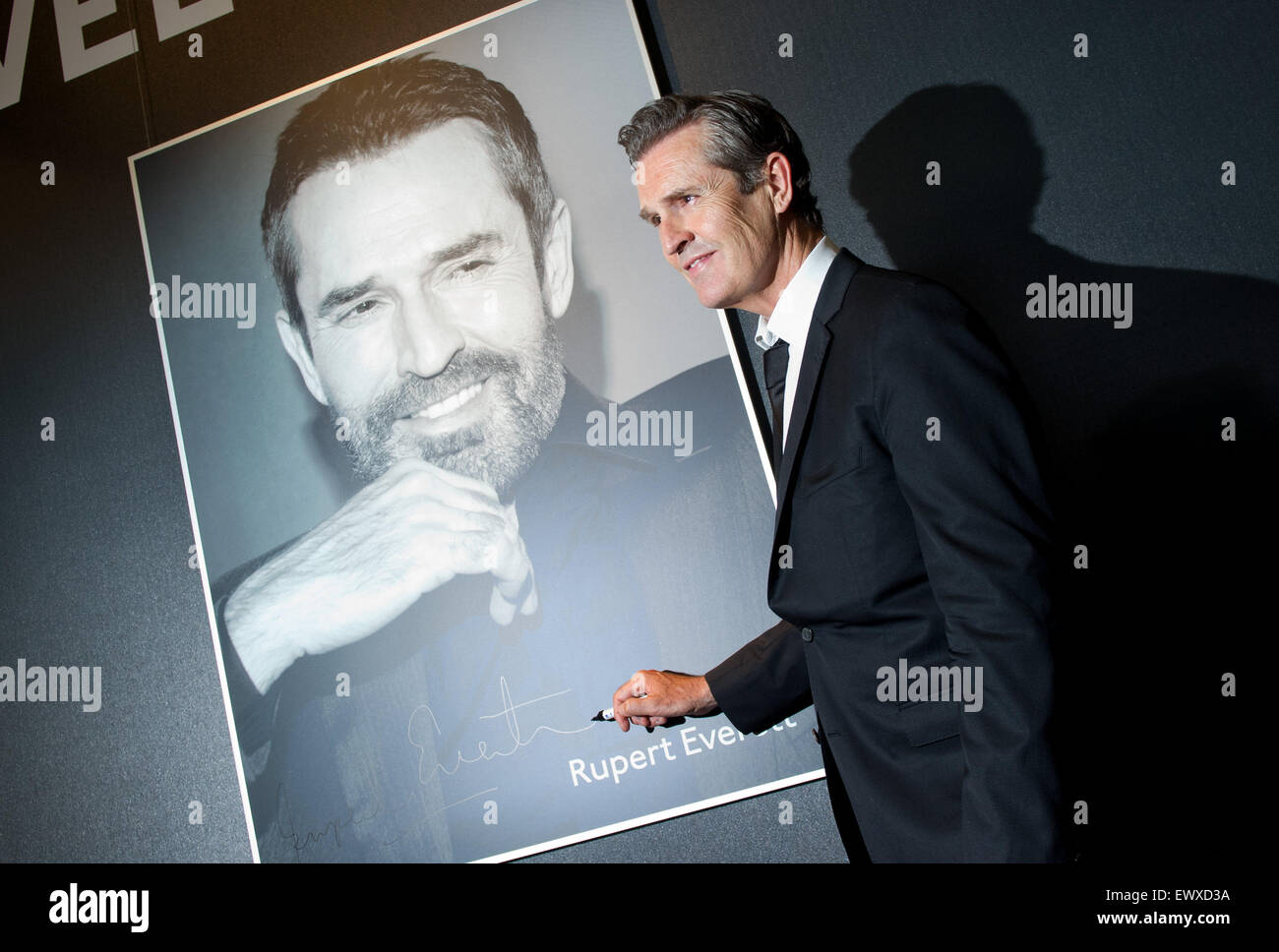 The British actor Rupertin Everett signs a portrait of himself after he ...