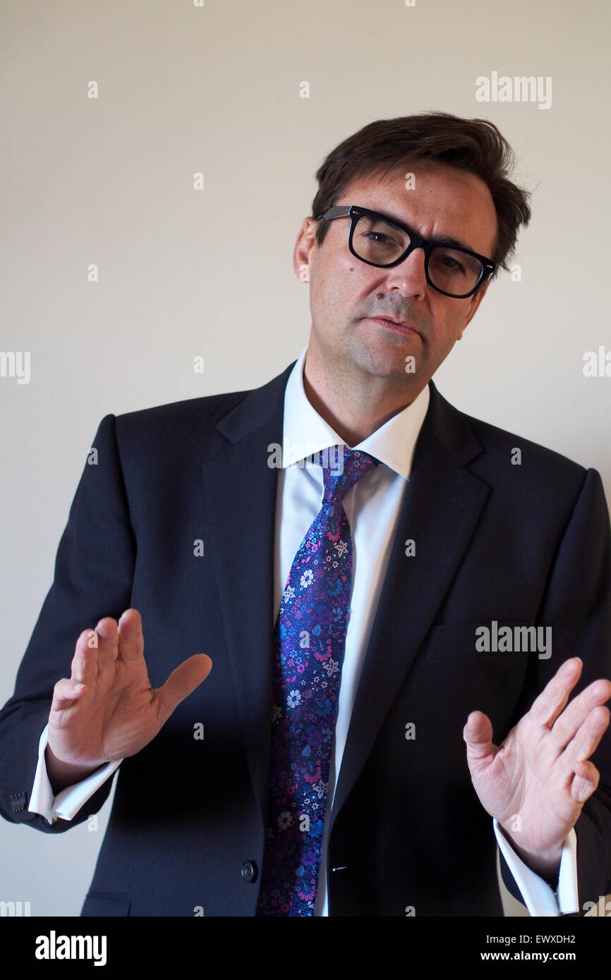 Smart middle-aged man in business suit and glasses gesticulating Stock ...