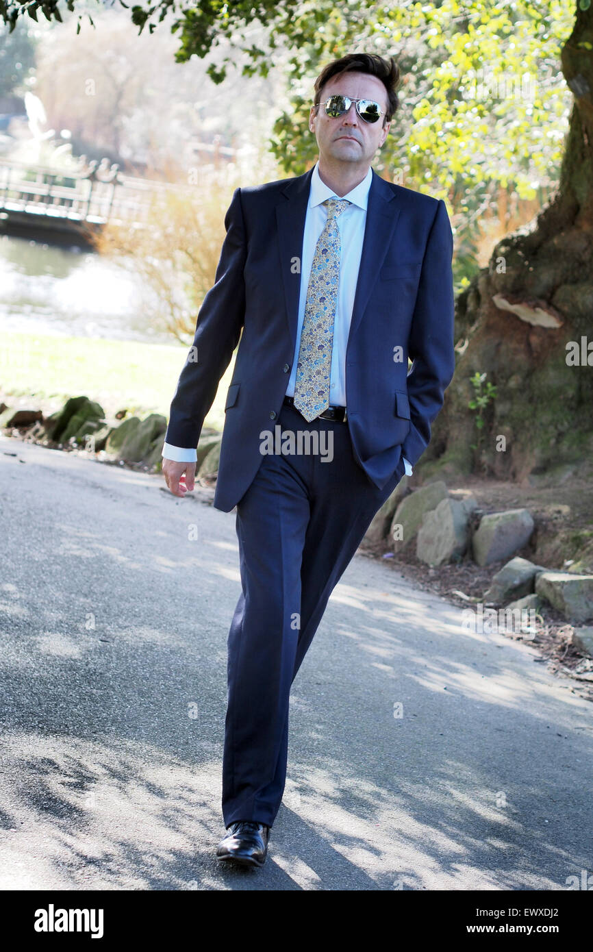 Smart middle-aged man in business suit and sunglasses Stock Photo - Alamy
