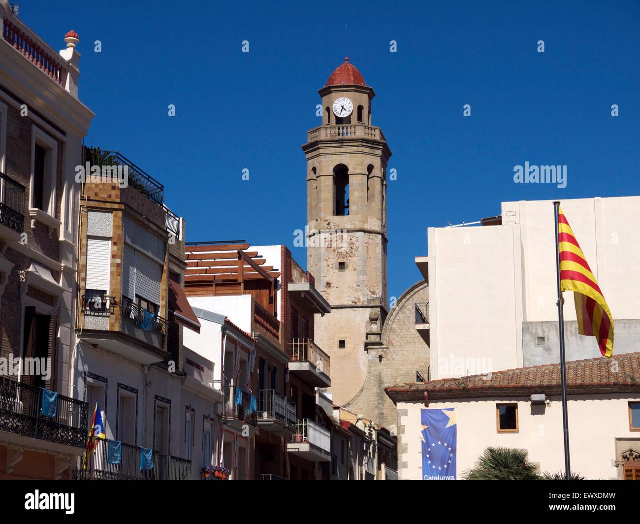 Church tower and Catalonia flag and old Spanish buildings Stock Photo ...