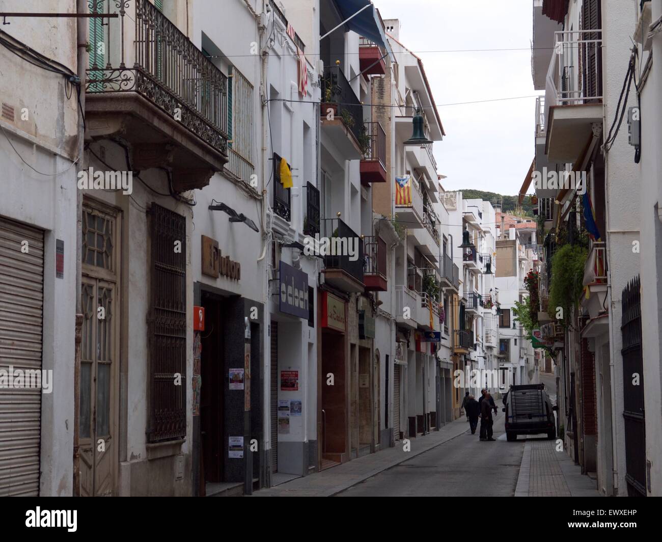 Typical Spanish street with shops and houses Stock Photo - Alamy