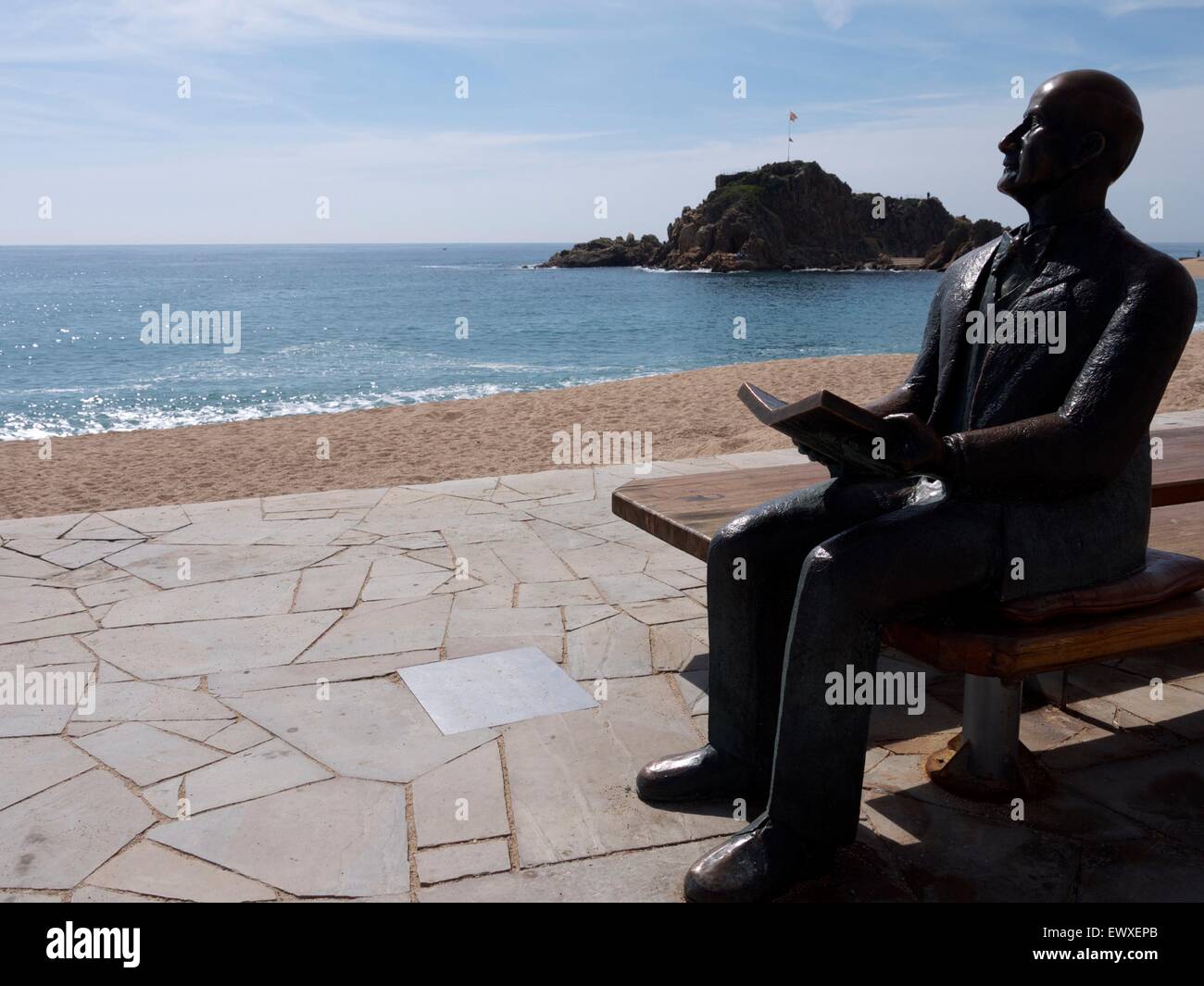 Statue on the beach with a rocky island in the background Stock Photo ...