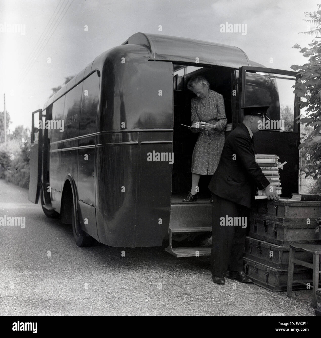 1950s, historical, a mobile library parked on a country lane with the ...