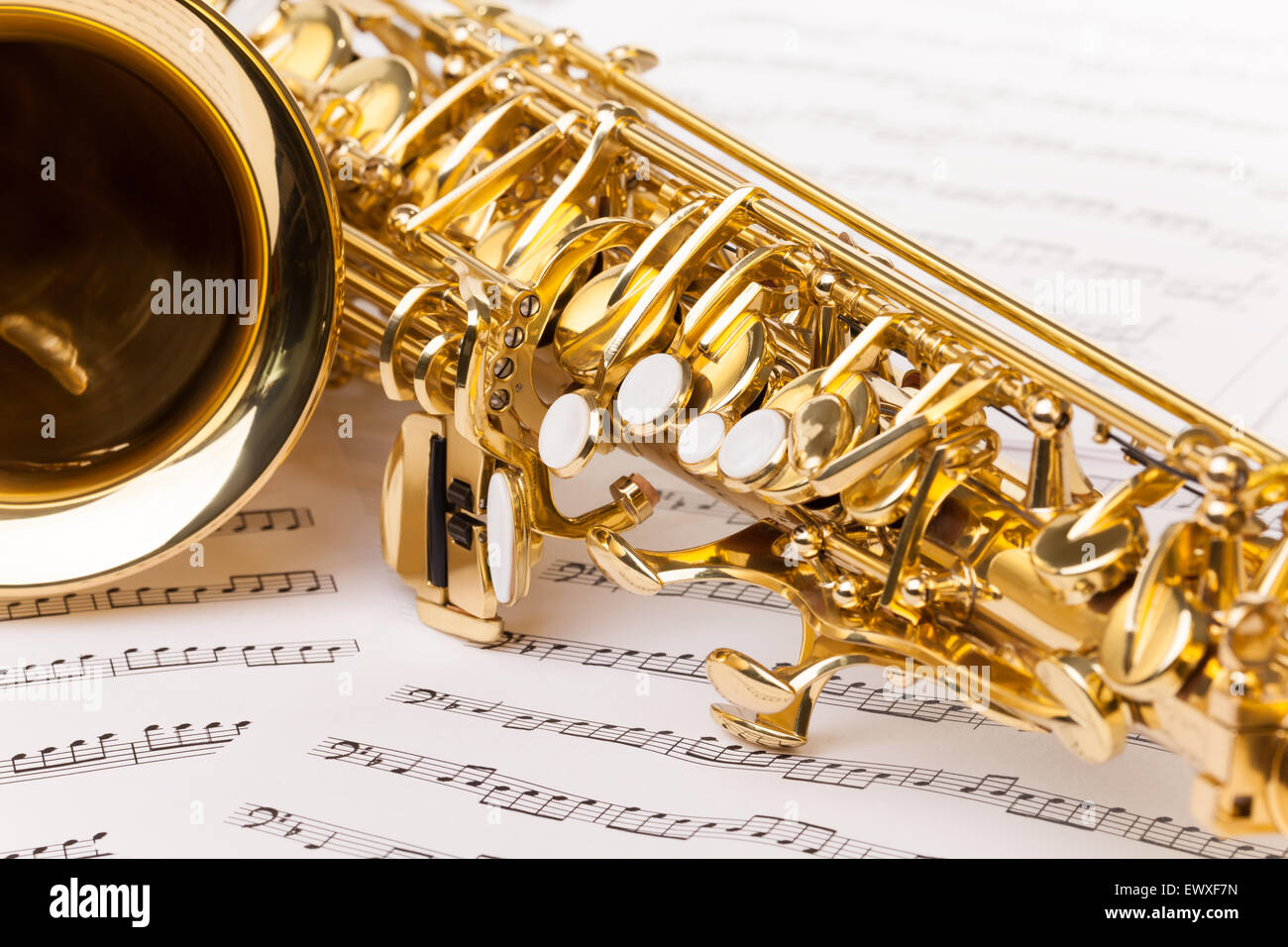 Beautiful golden alto saxophone on musical notes Stock Photo - Alamy