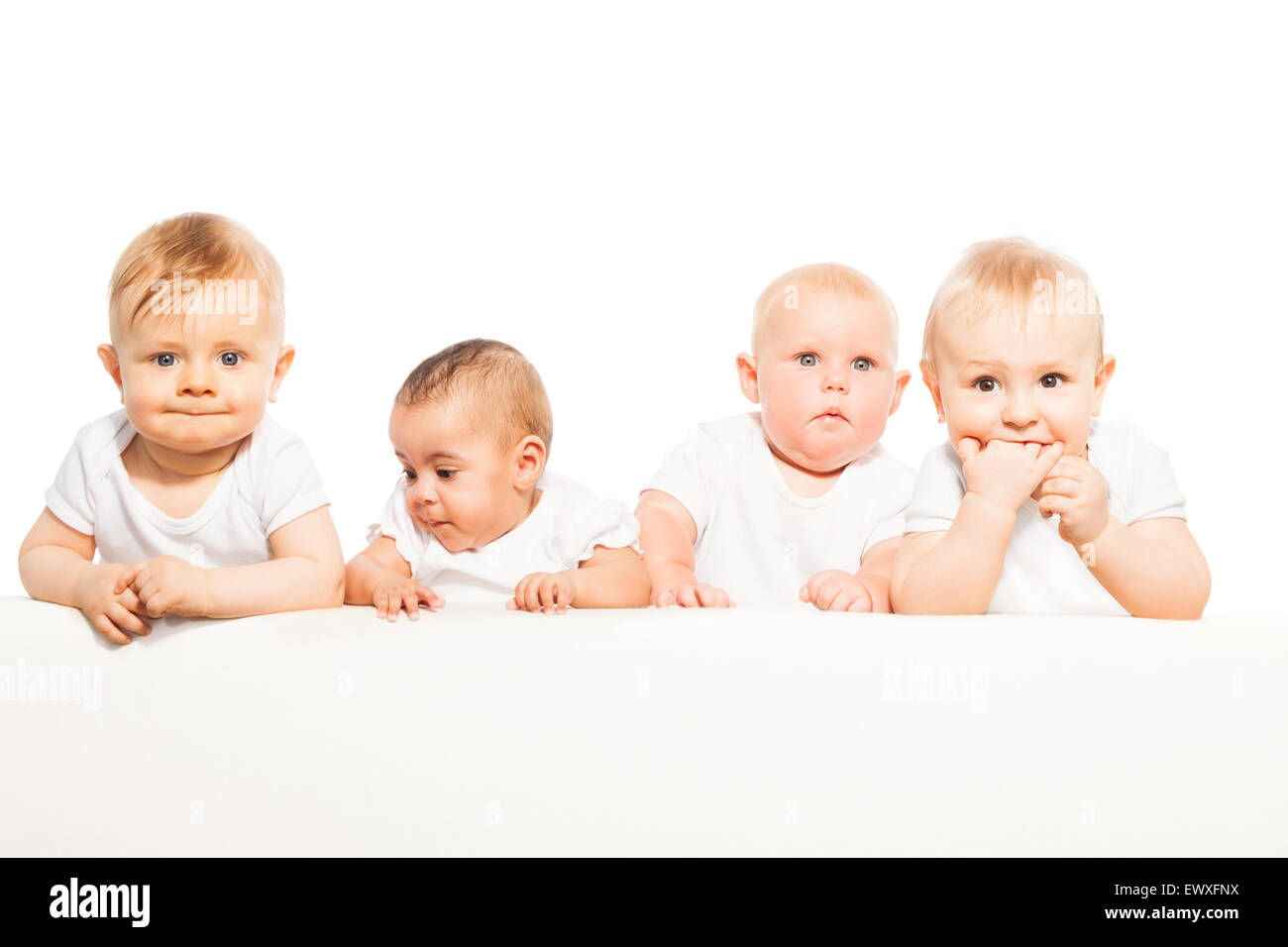 Four babies stand in a row on the white background Stock Photo - Alamy